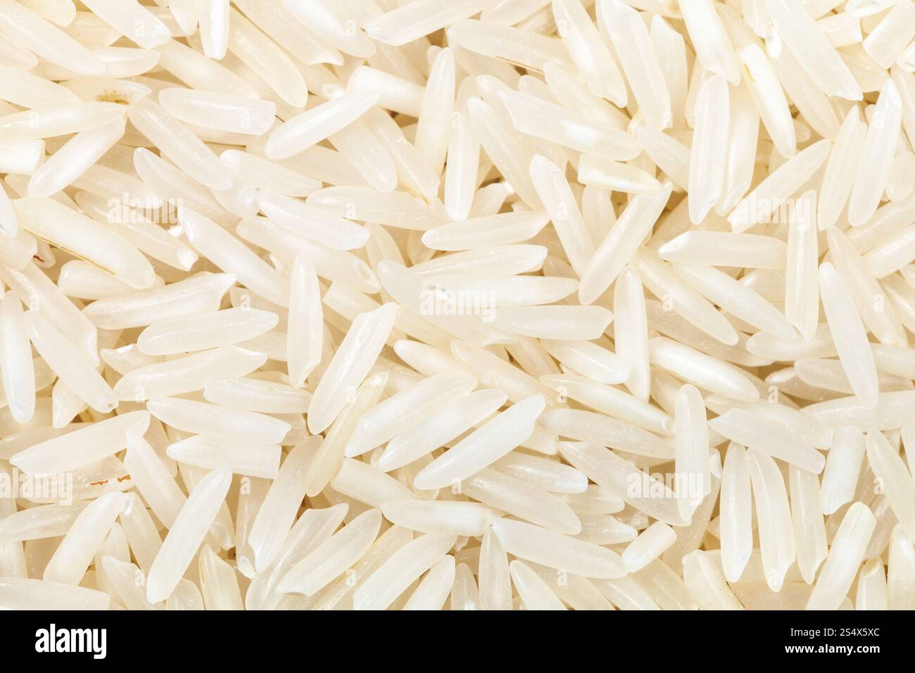food background - long-grain uncooked white Basmati rice close up Stock ...