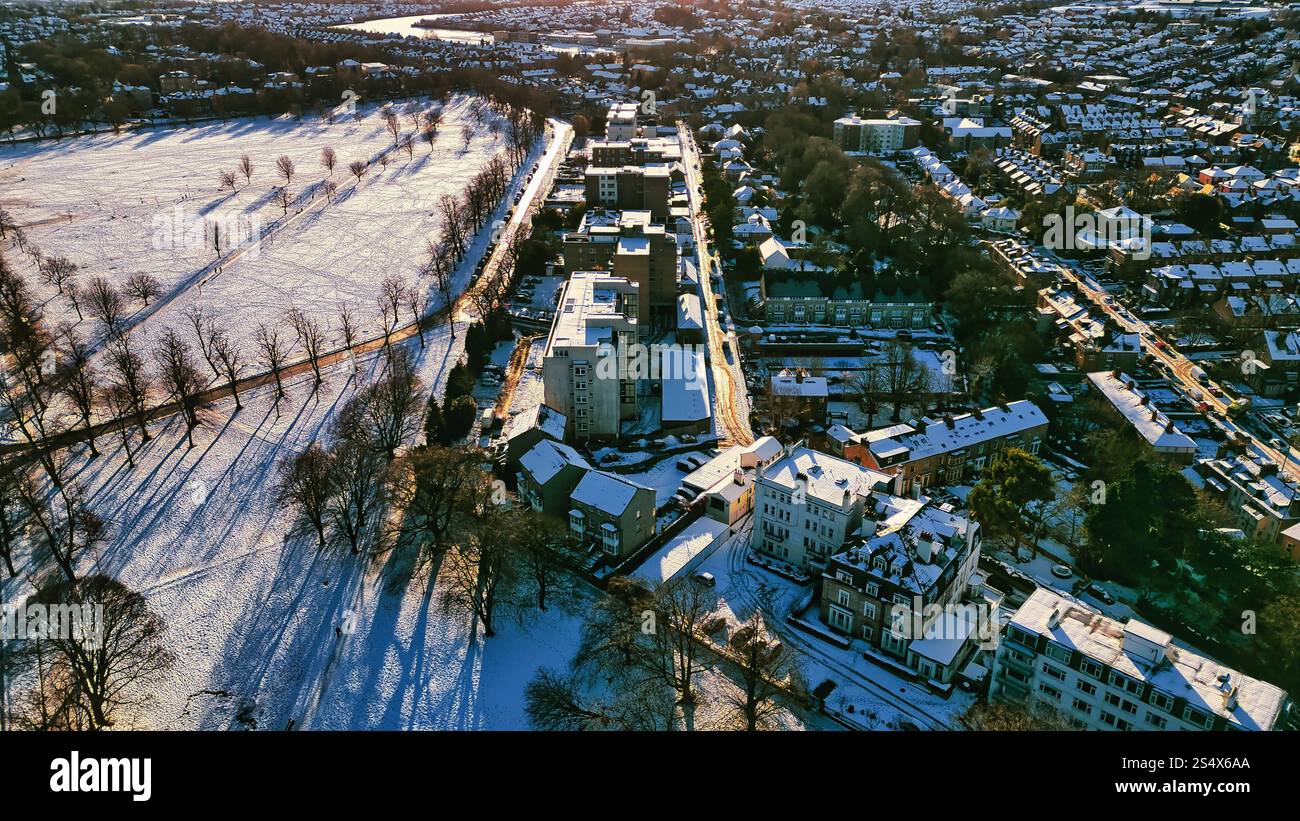 Aerial view of a snow-covered residential area and park. Buildings ...
