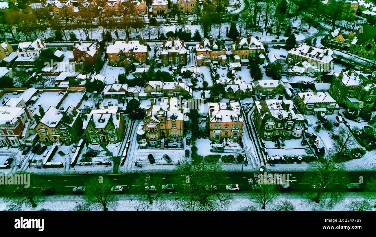 Aerial view of a snow-covered residential neighborhood featuring two ...