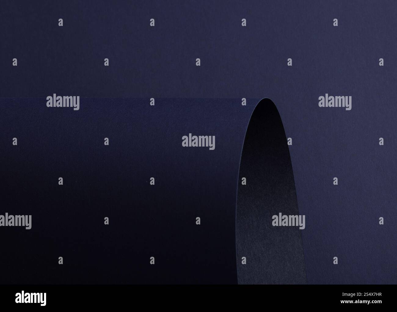 Midnight blue paper background with curved, matte surfaces and a smooth ...