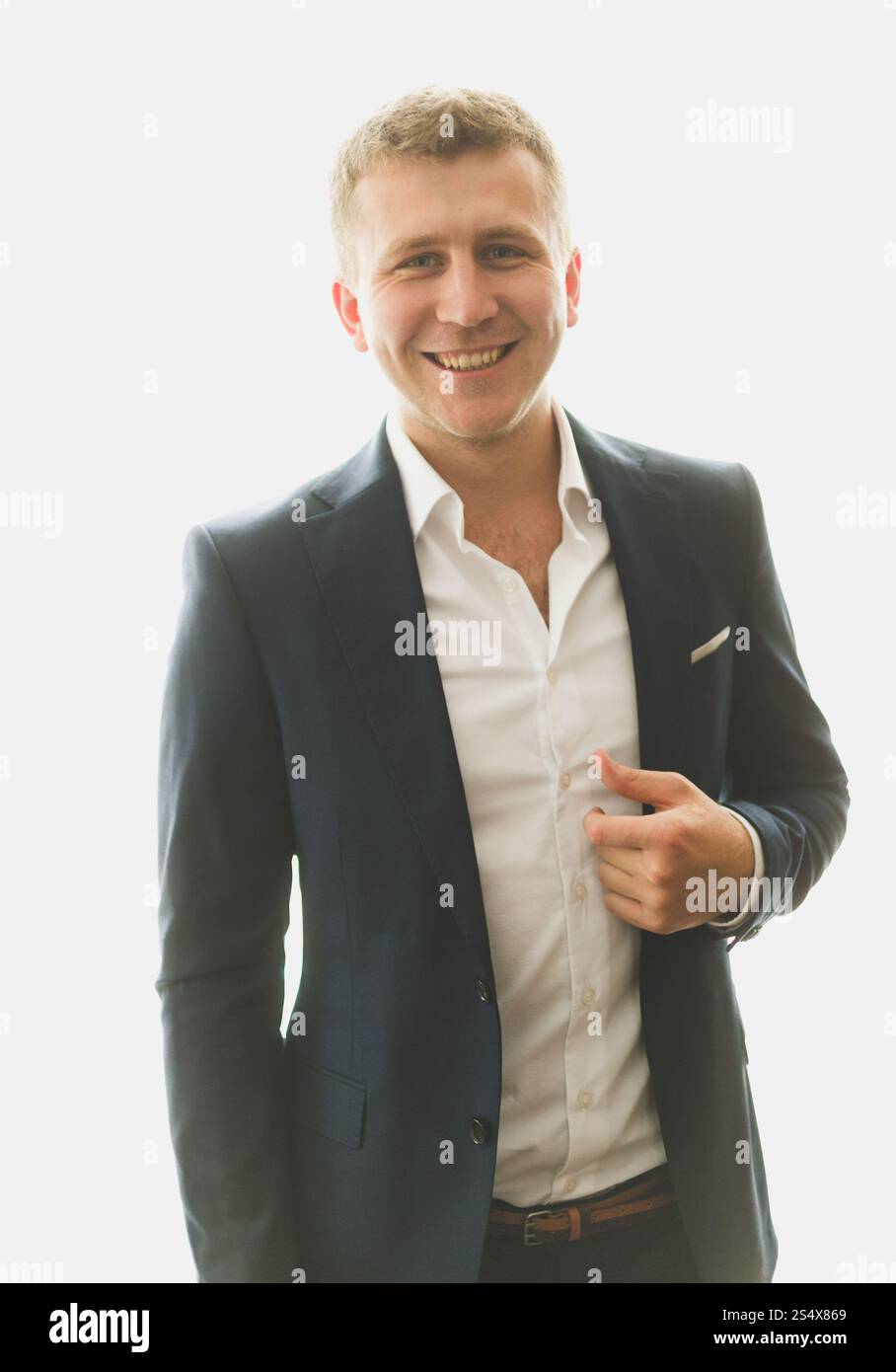 Toned portrait of handsome smiling man in white shirt and blue jacket ...