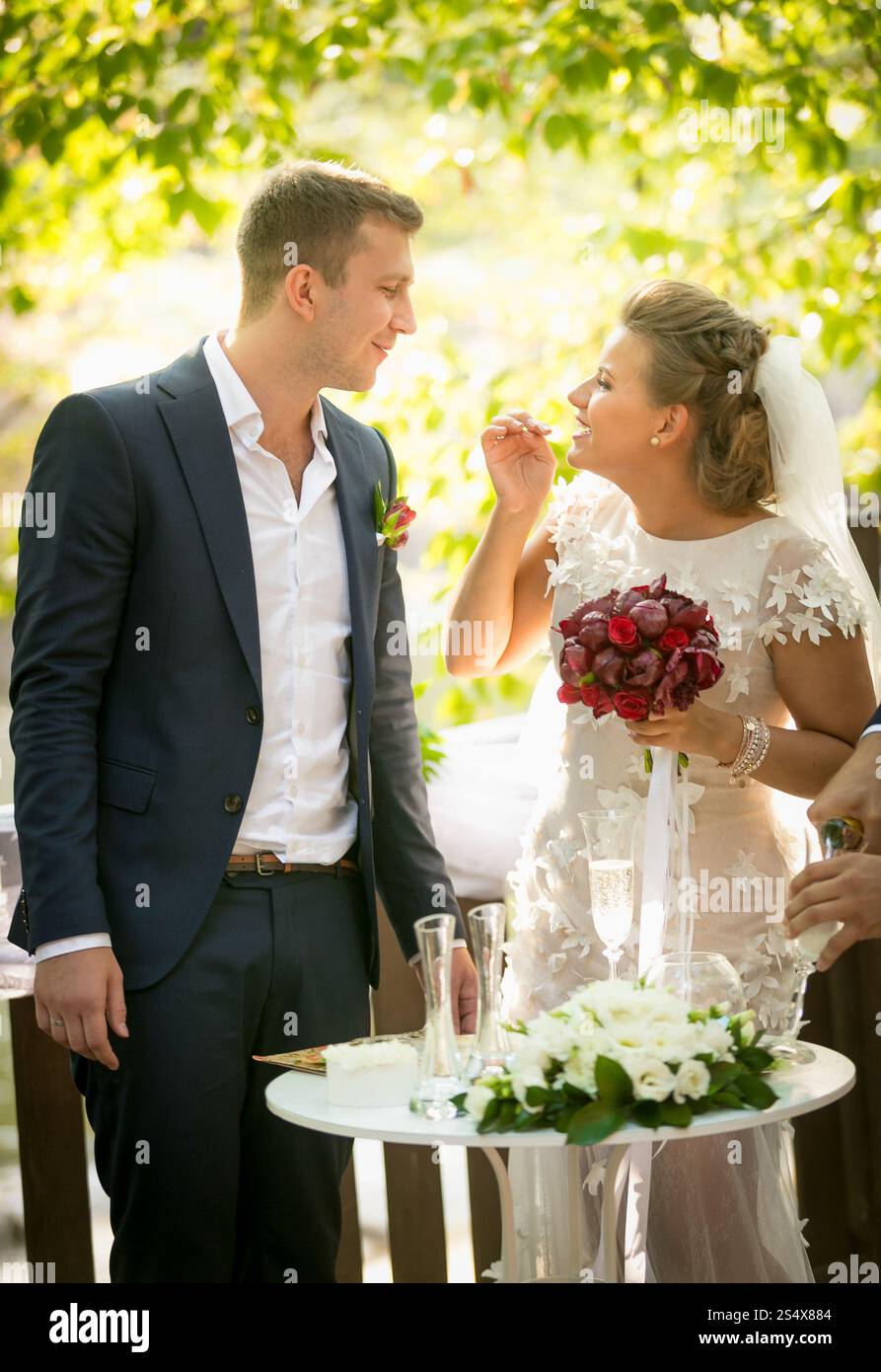 Portrait of laughing bride and groom looking at each other at wedding ...