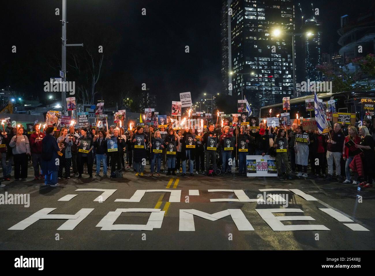 Demonstrators hold torches during a protest calling for the immediate ...