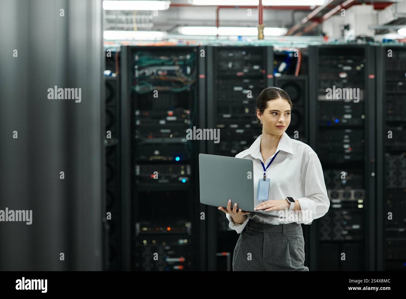 A skilled IT specialist works diligently in a high-tech server room ...