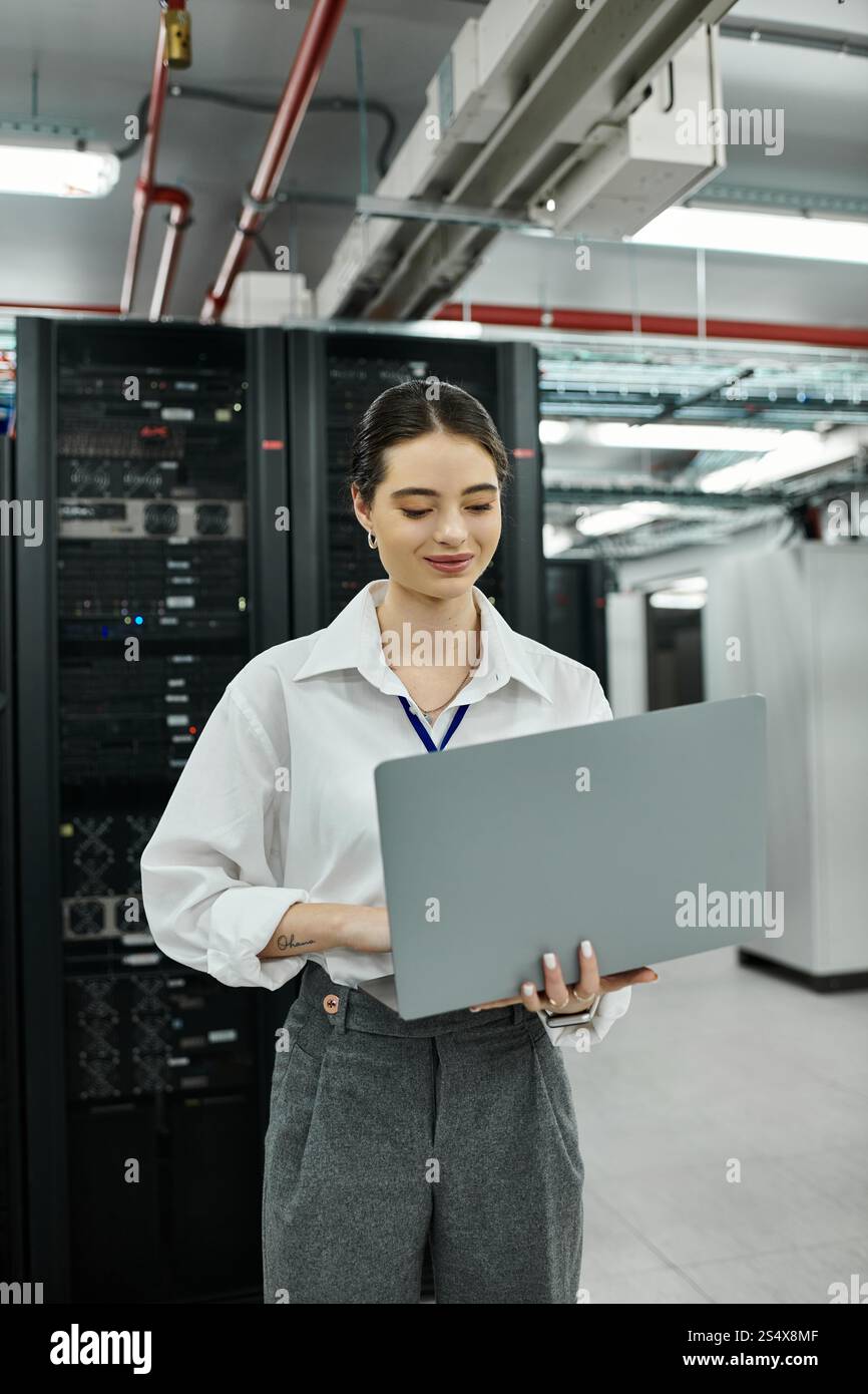 A professional woman in a white shirt operates her laptop in a busy ...