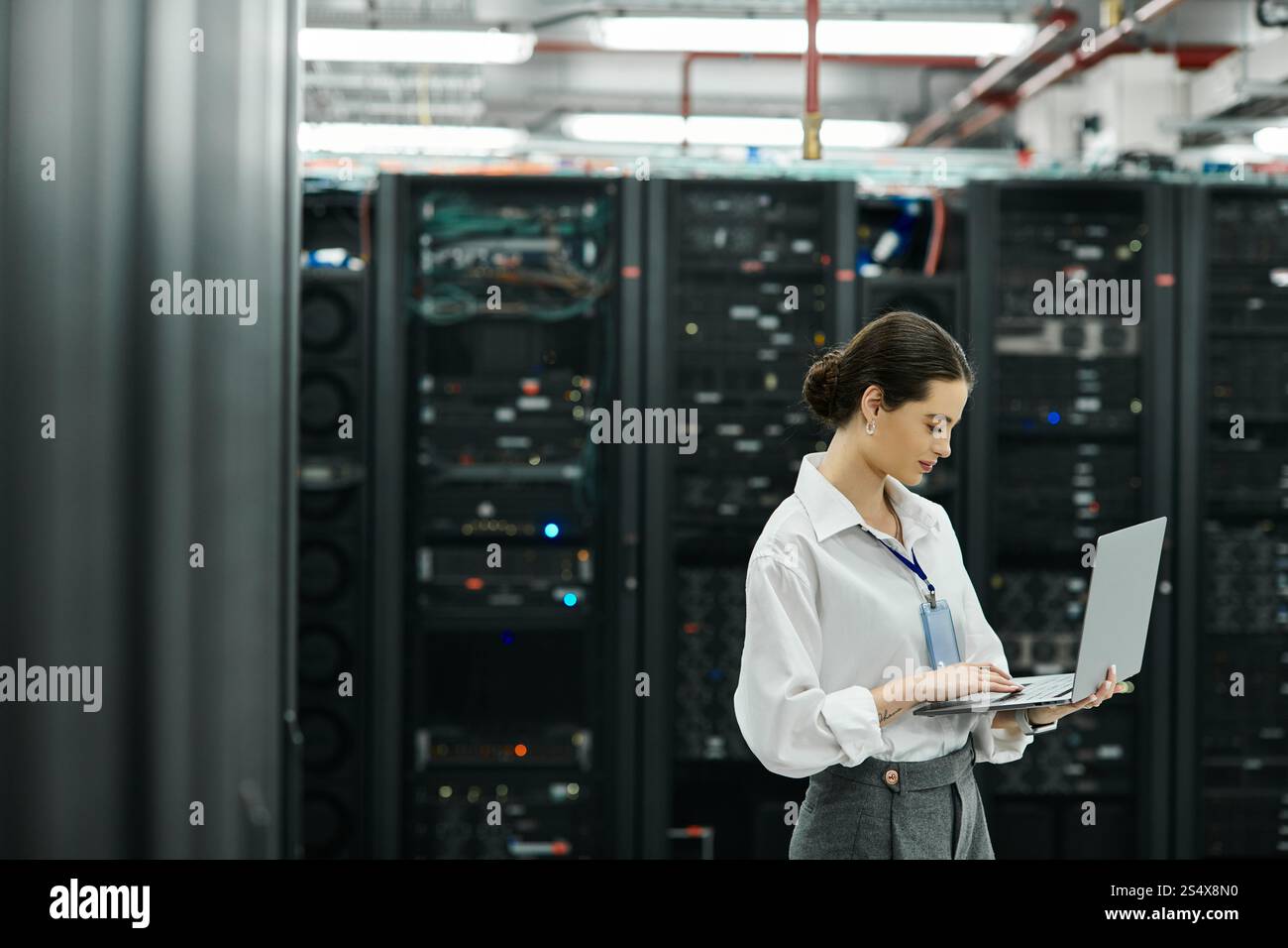 An IT specialist in a white shirt works diligently in a busy server ...