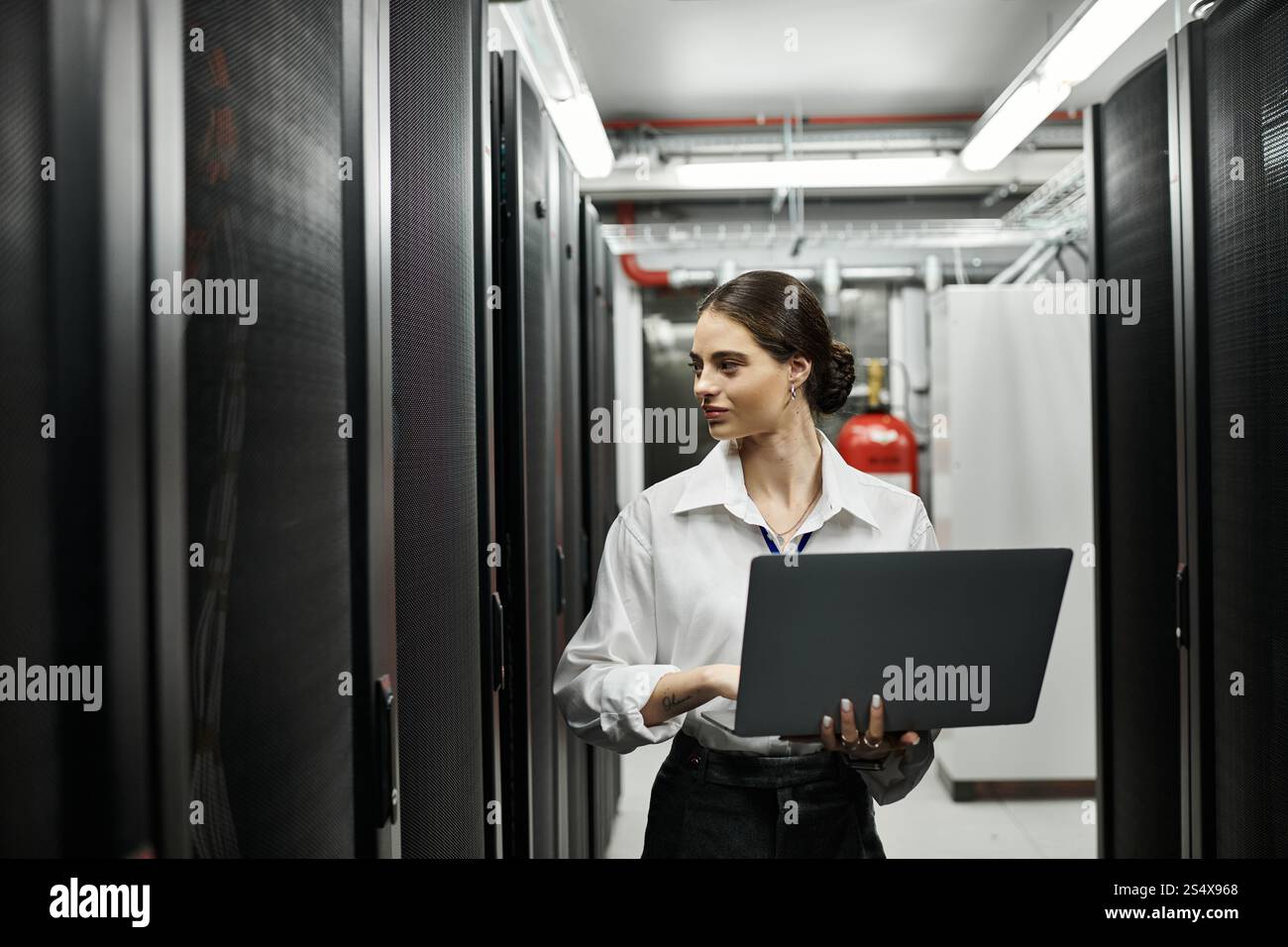 An IT specialist navigates through a modern server room, handling ...