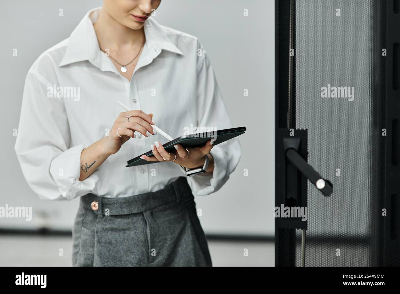 A skilled professional in a white shirt focuses on server management ...