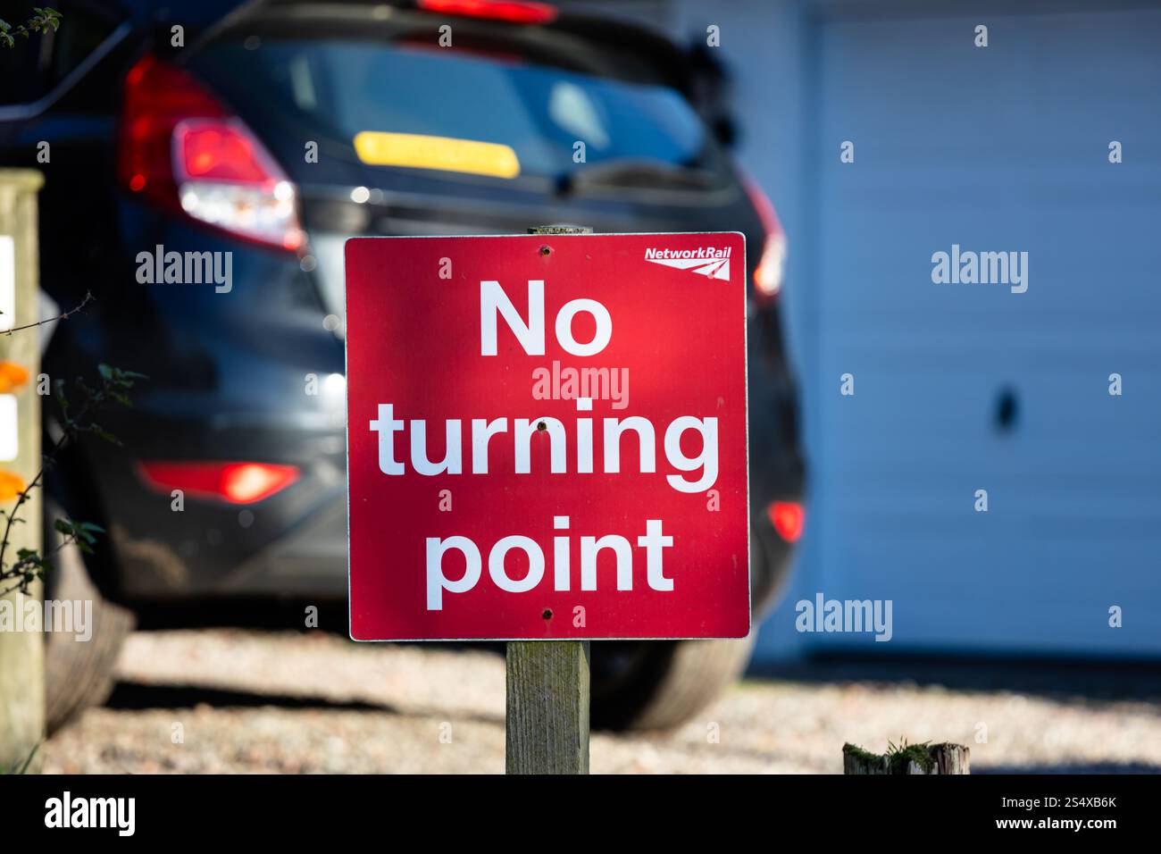 A red "No turning point" sign with white text, indicating that vehicles ...
