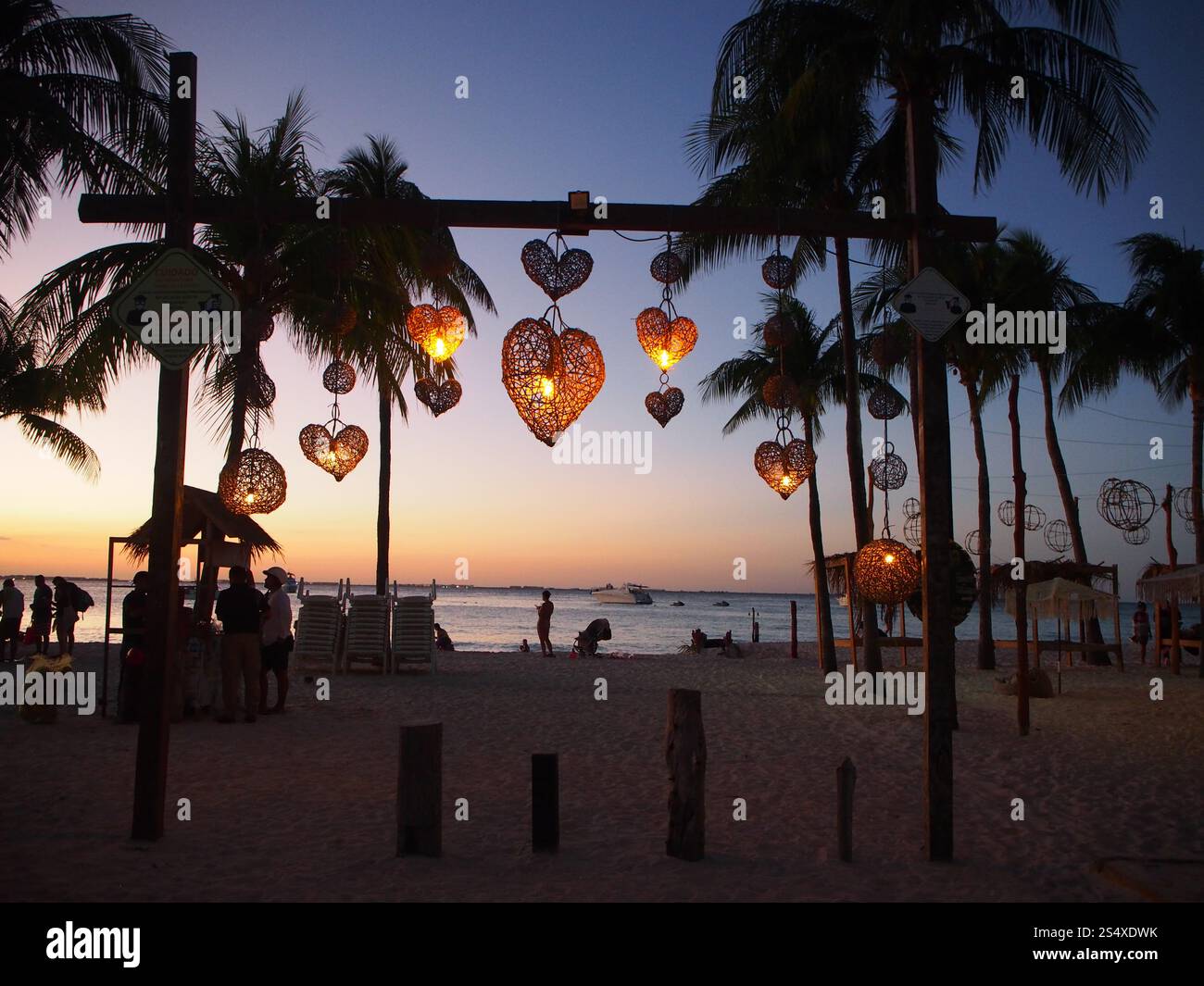 An entrance to Playa Norte decorated with light on the Isla Mujeres ...