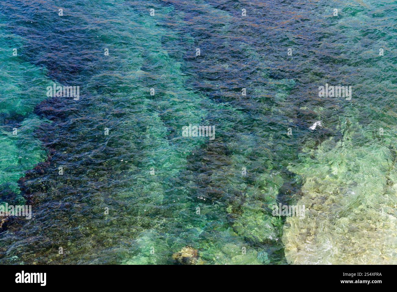 Limpid sea water surface with stones on bottom. View from above. Nature ...