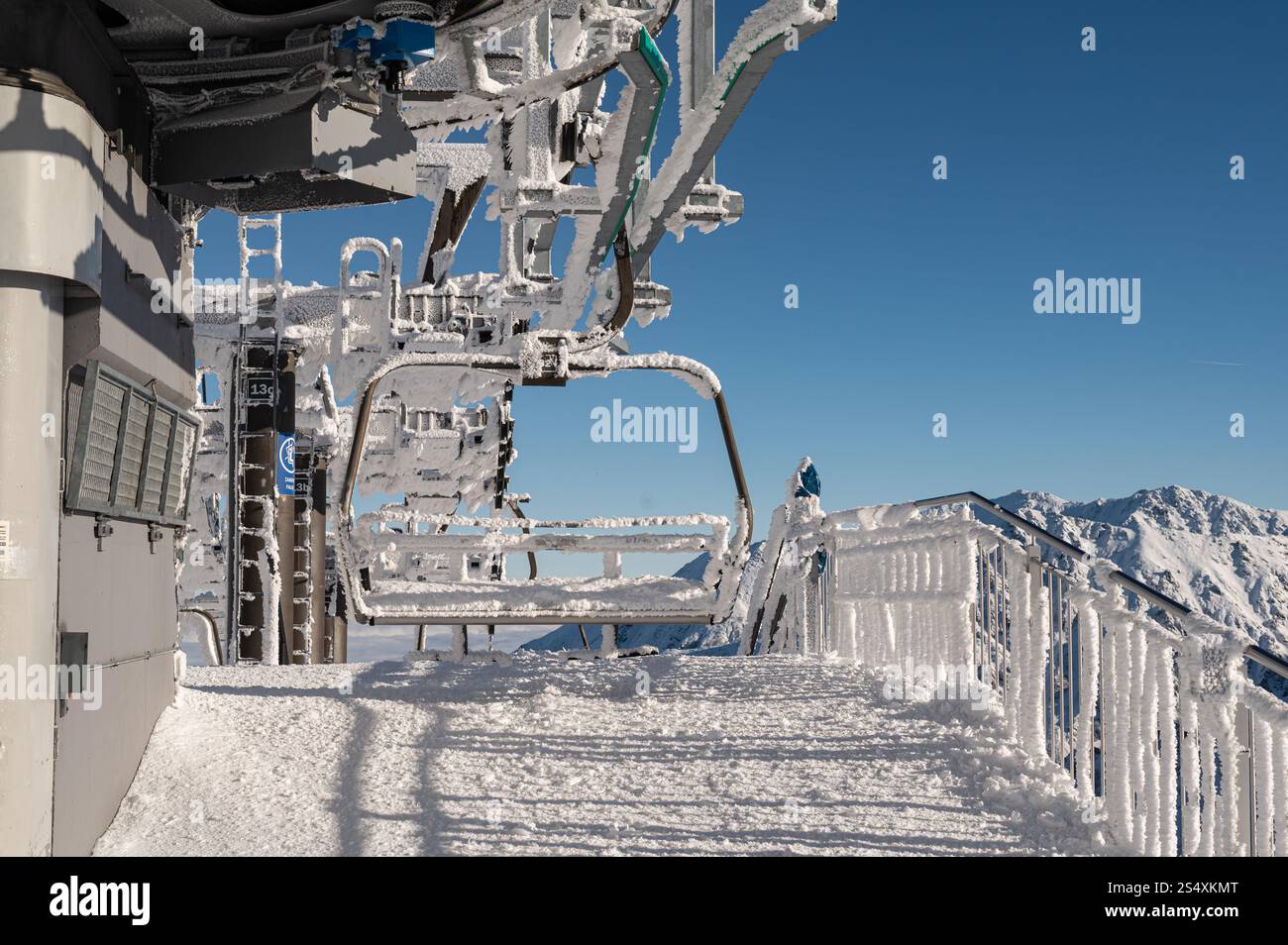 Empty chairlift station and benches at a shut down ski resort in the ...