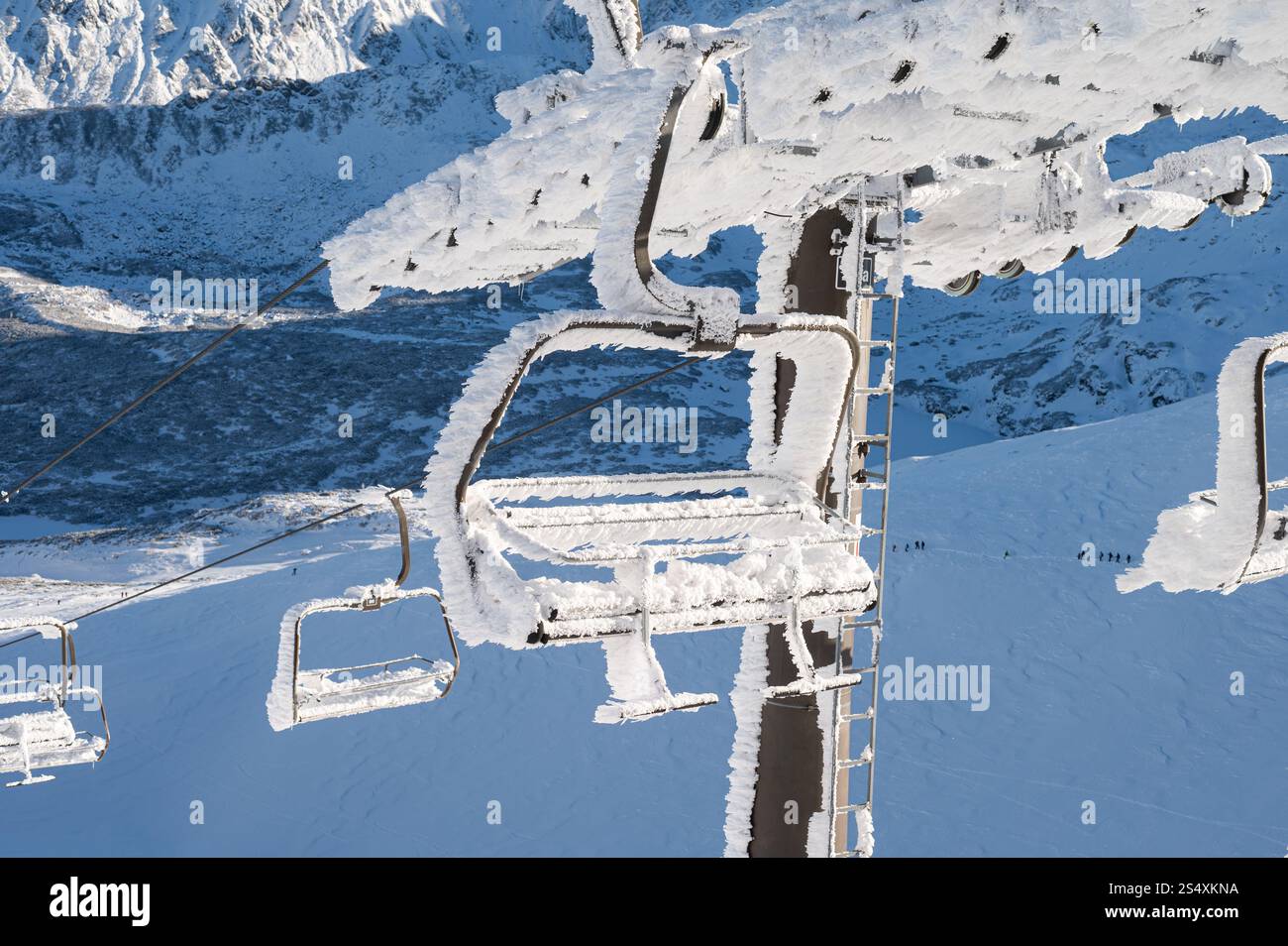 Empty chairlift station and benches at a shut down ski resort in the ...