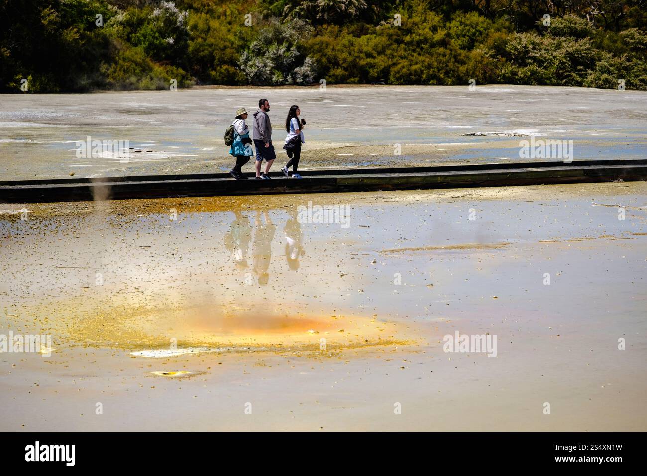 Visitors walking on boardwalk crossing Champagne Pool at Wai-O-Tapu ...
