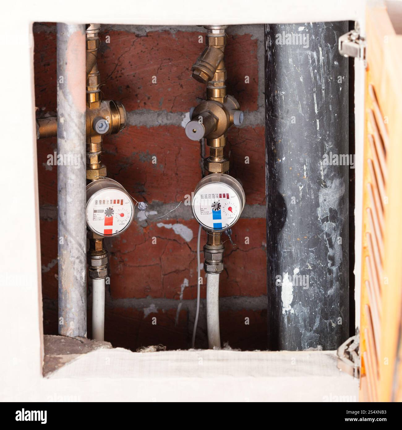 new mechanical water meters on pipes in niche Stock Photo - Alamy