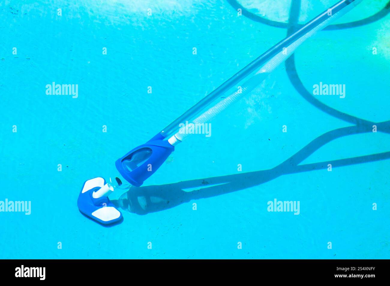 cleaning of swimming pool by underwater vacuum cleaner Stock Photo - Alamy