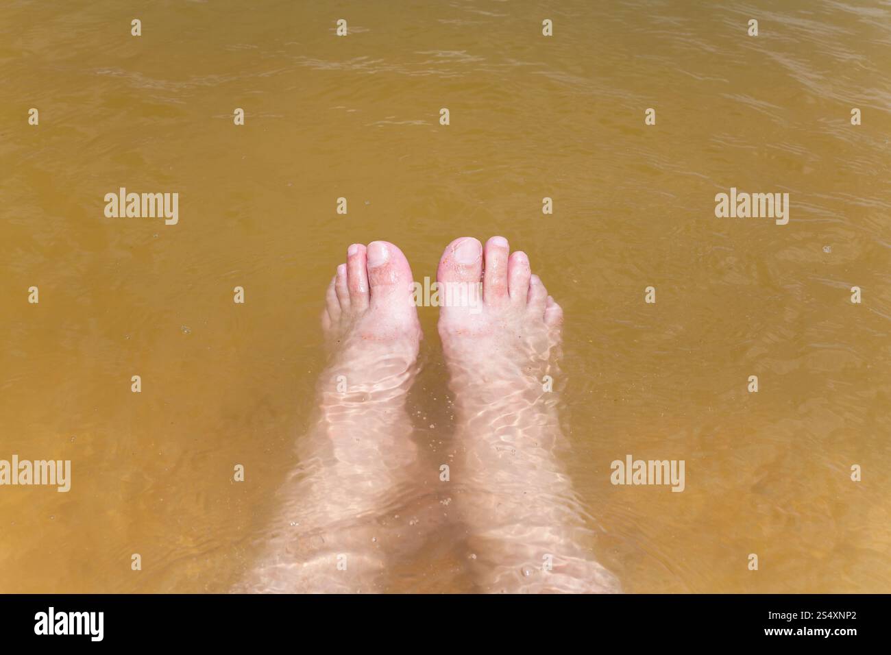 medical treatment - male legs in sea water. Sea of Azov, Temryuk bay ...