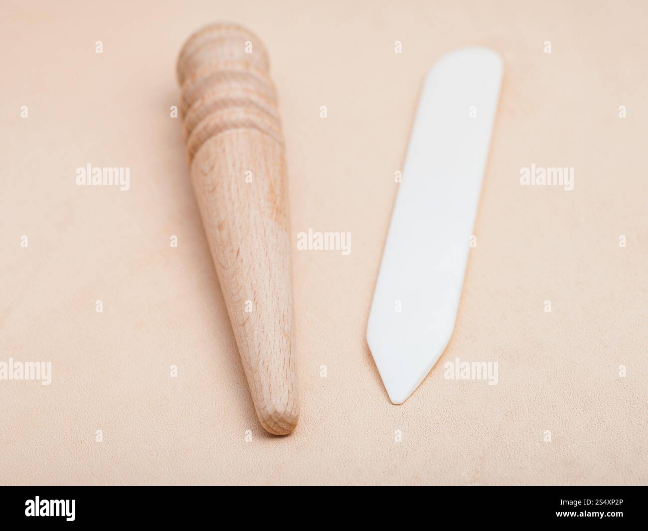 Leather crafting tool - flat plastic and round wooden slickers on ...