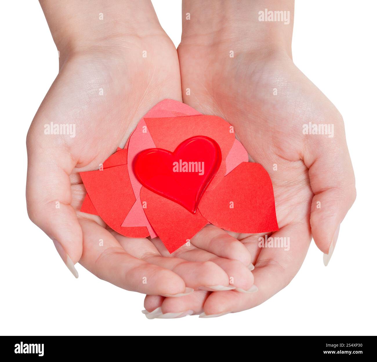 one red heart above pile of paper hearts on female palms isolated on ...