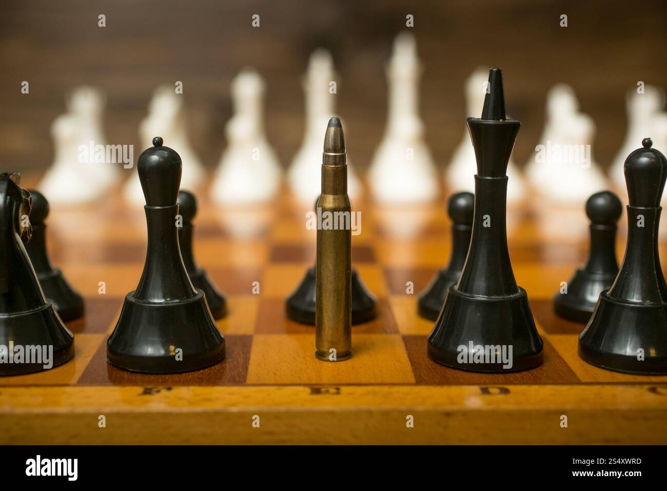 Closeup photo of bullet standing on place of queen chess piece Stock ...