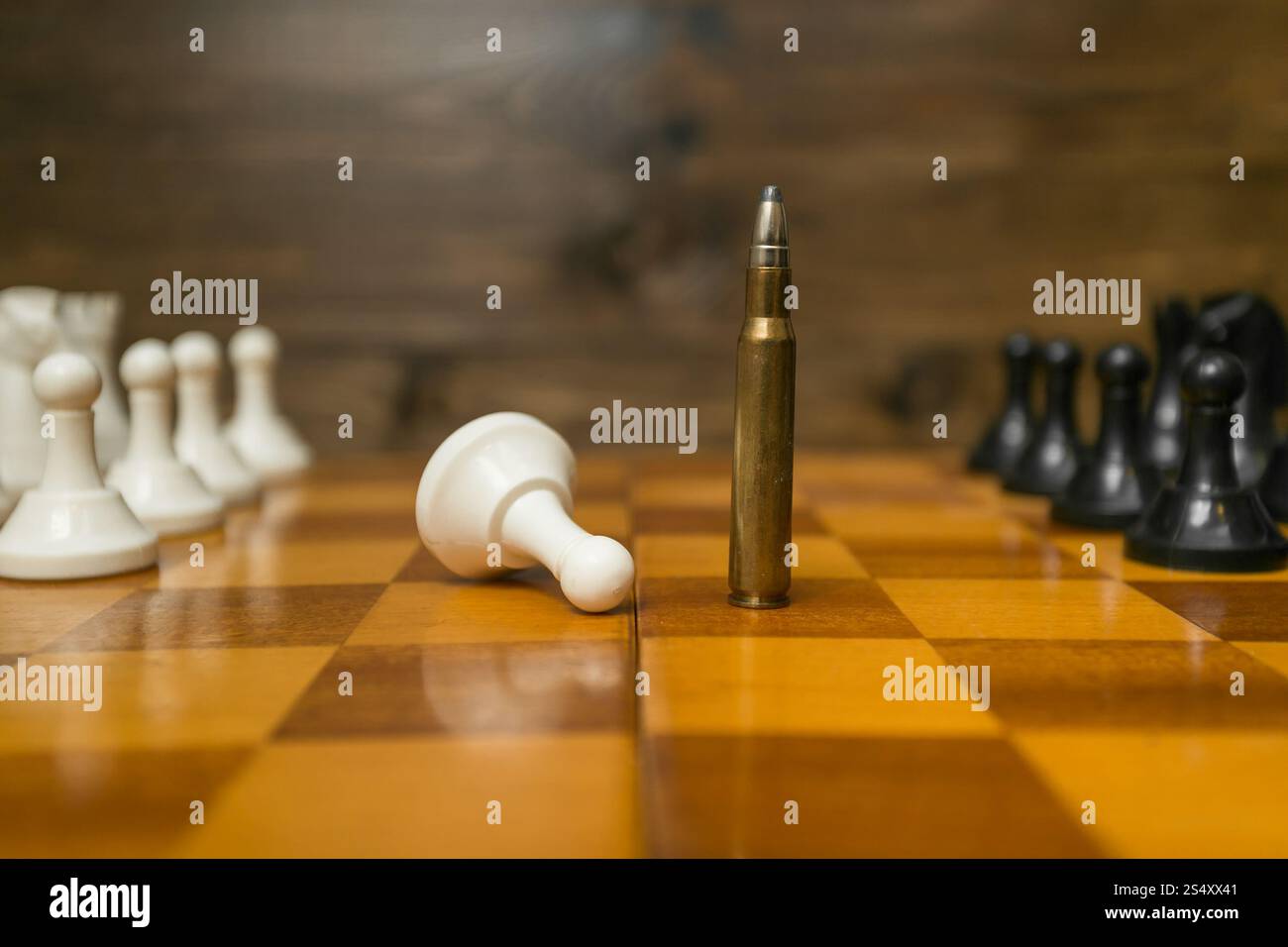 Conceptual photo of riffle bullet on chessboard. Concept of power of ...