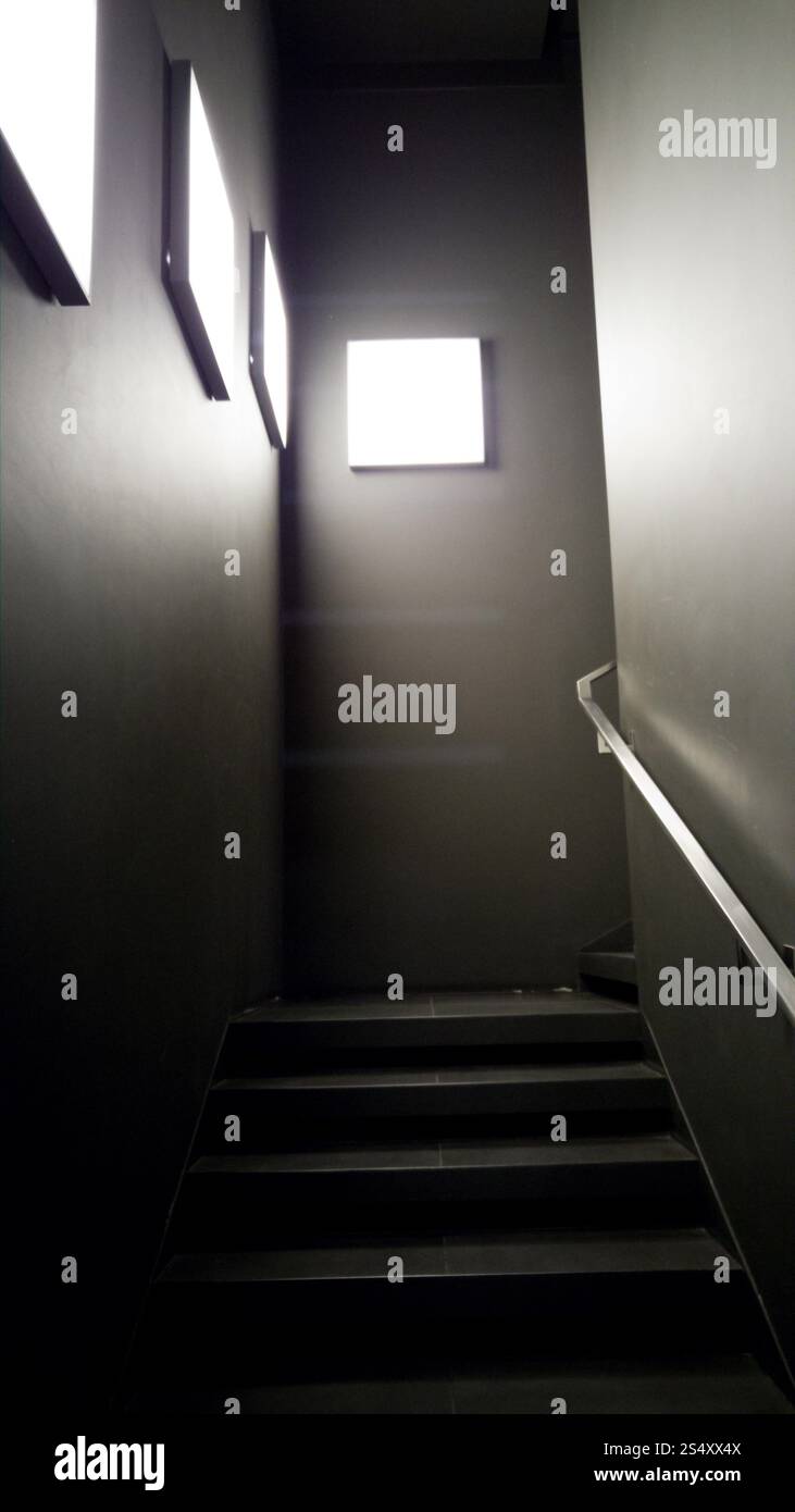 Dark stairs in modern building illuminated by light panels Stock Photo ...