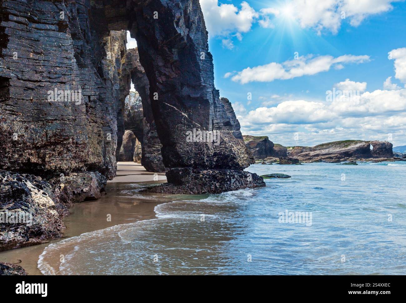 Natural rock arches on Cathedrals beach in low tide (Cantabric coast ...