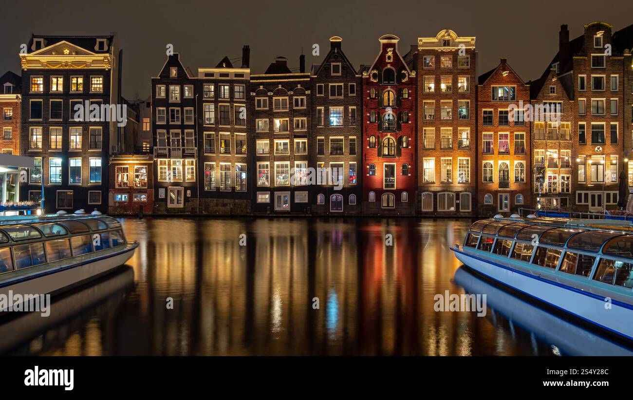 Medieval houses and cruise boats at the Damrak in Amsterdam the ...
