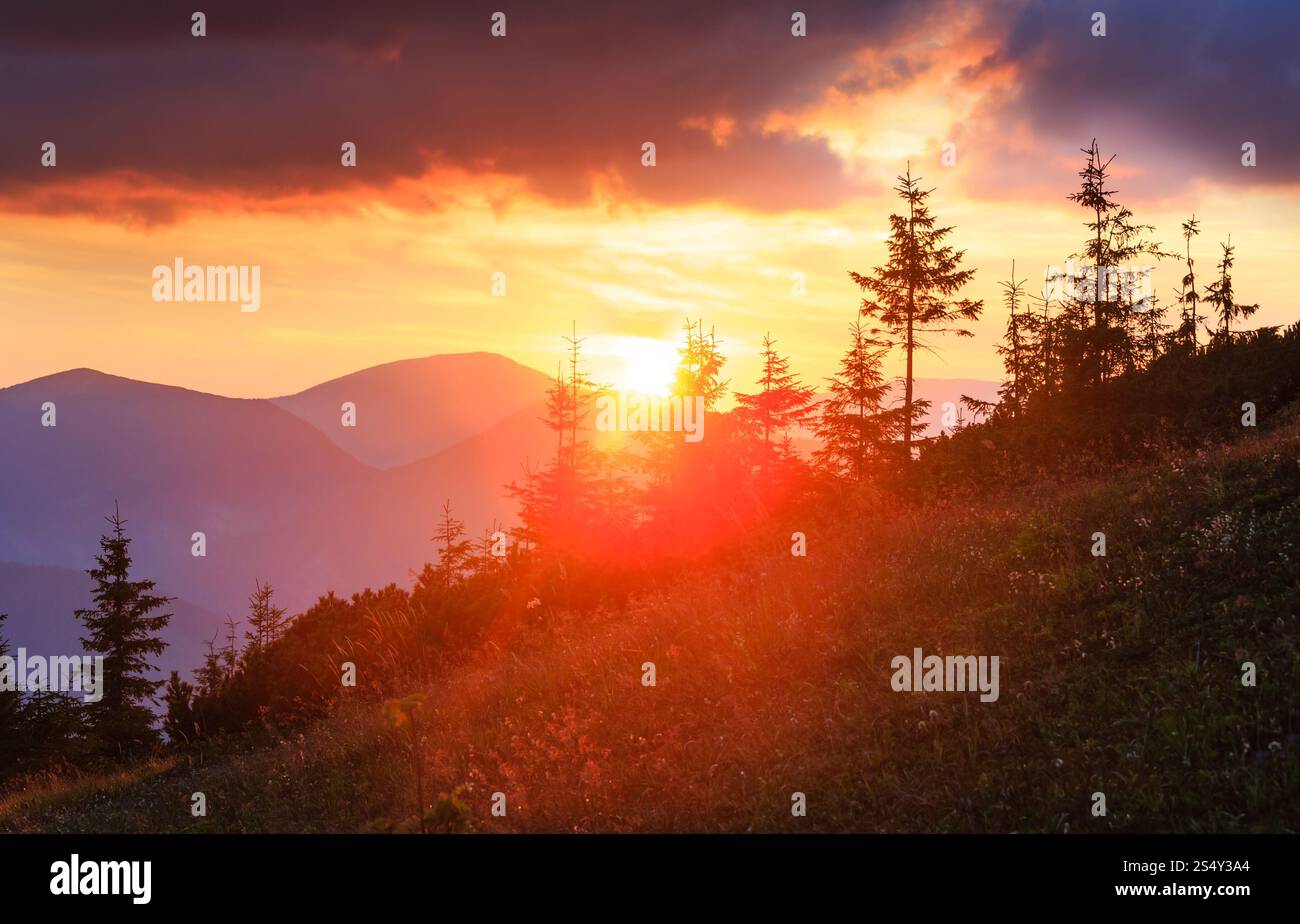 Last rays of setting sun in evening sky with clouds. Summer sunset ...