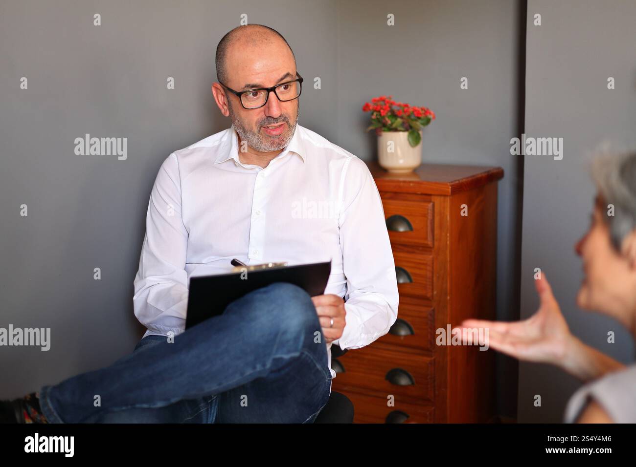 In a modern office, a therapist provides a confidential space for a ...