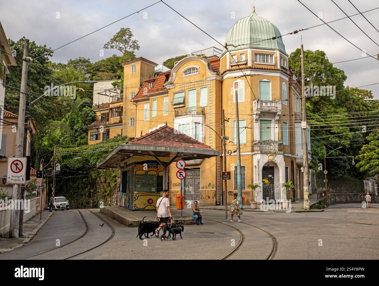 A man walks his dogs past a Tram Stop in Santa Teresa, Rio De Janeiro ...