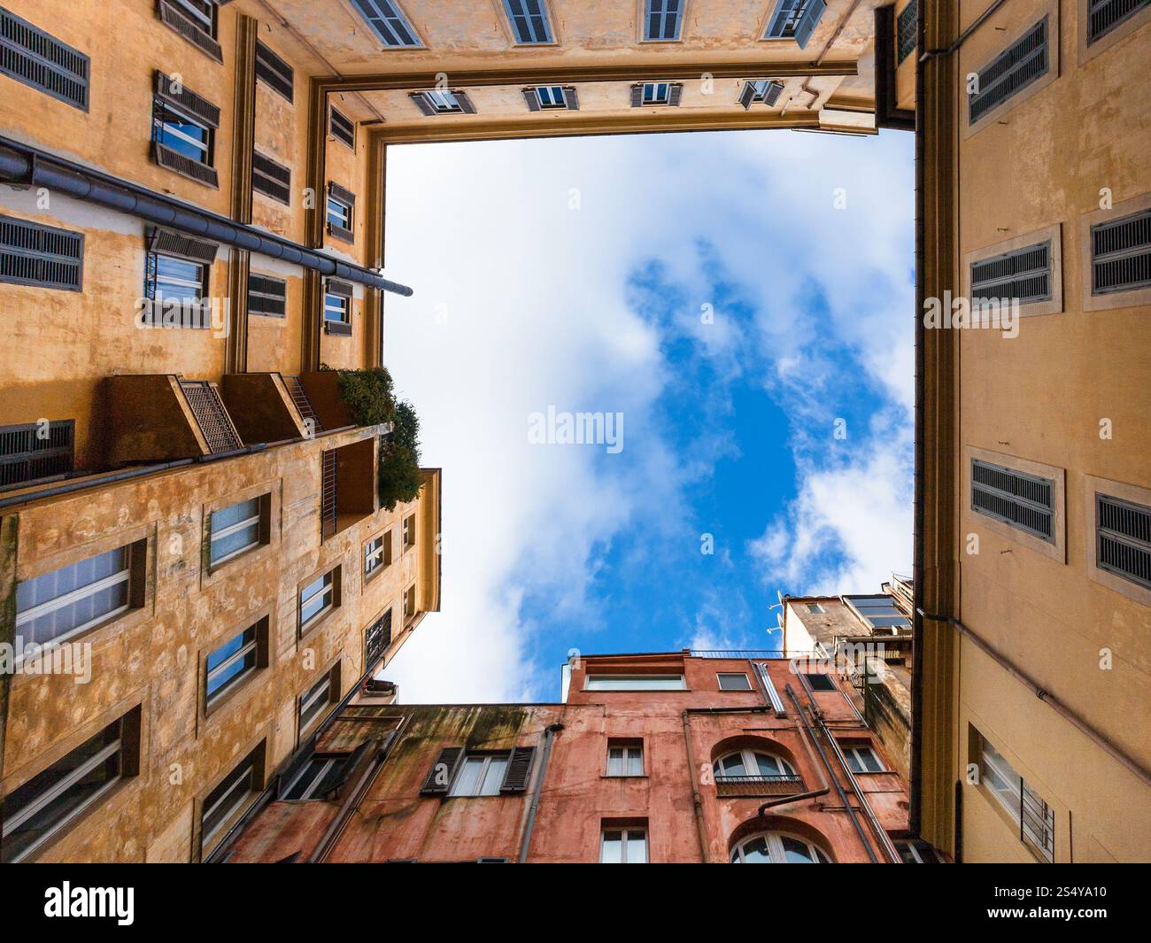 Travel to Italy - bottom view of square sky from pation of urban house ...