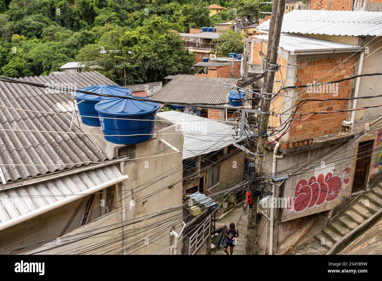 A man walks through an alley in Favela Pereira da Silva, Rio De Janeiro ...
