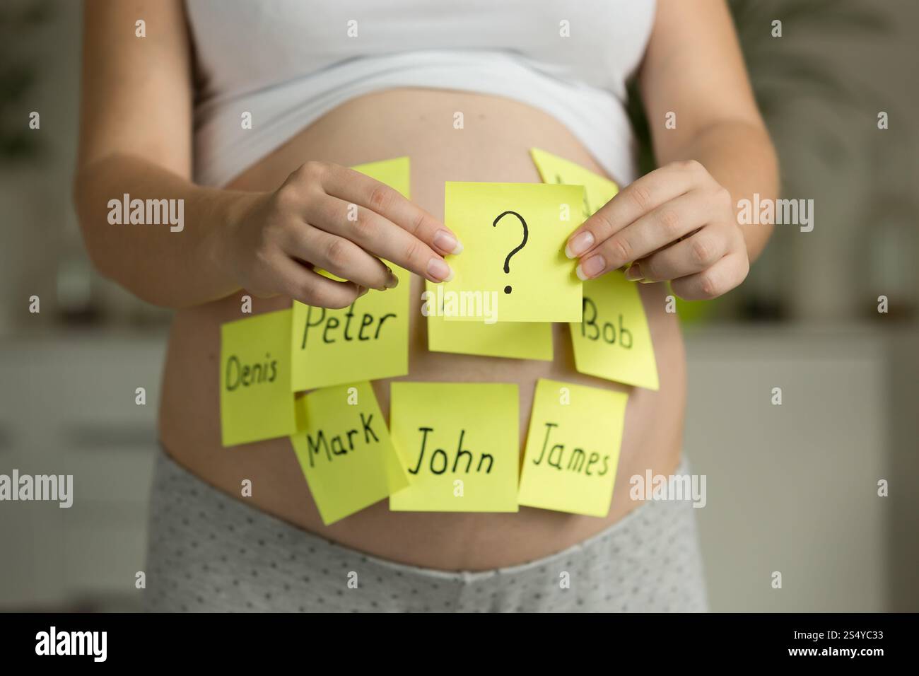 Conceptual image of pregnant woman choosing future baby name Stock ...