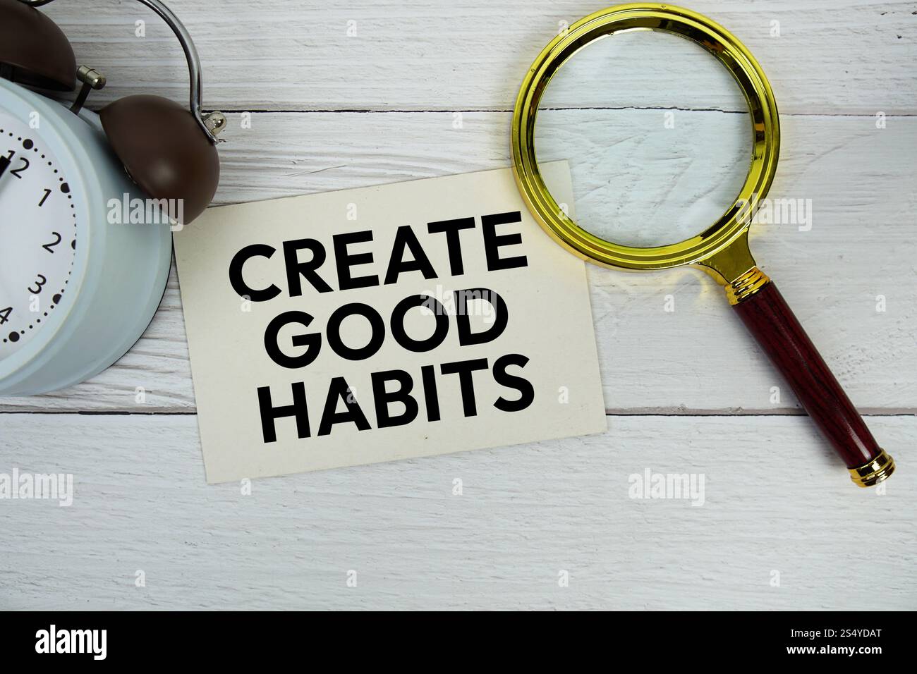 Create Good Habits text message on sticky note with magnifying glass ...