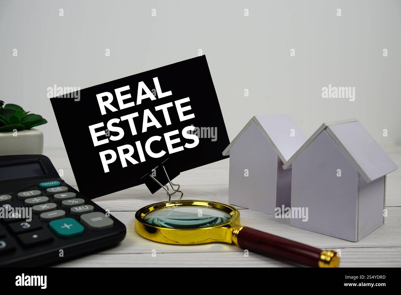 Real Estate Prices text message on sticky note with alarm clock ...