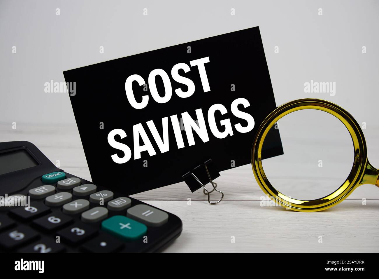 Cost Savings text message on sticky note with magnifying glass and ...