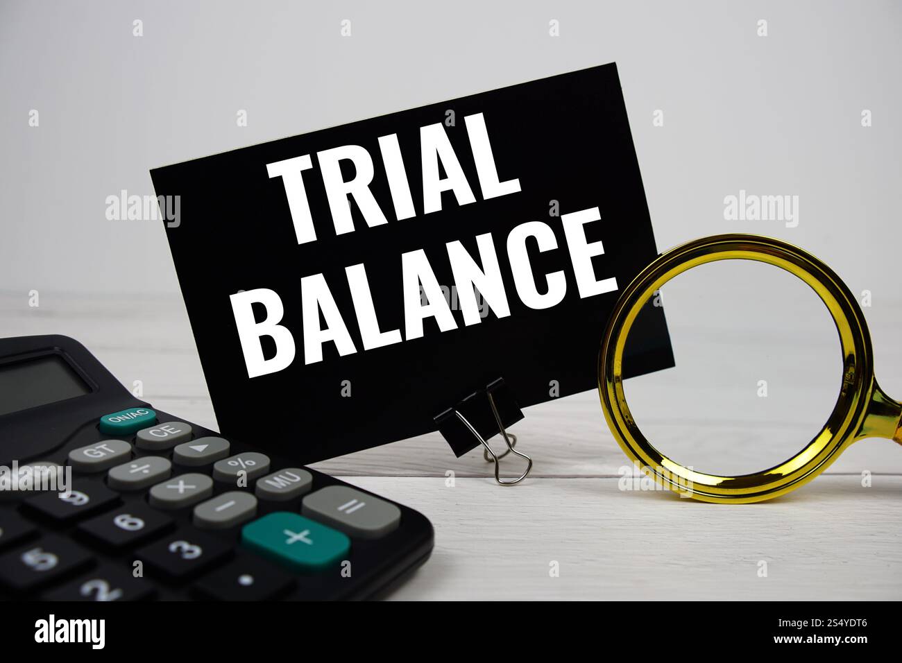 Trial Balance text message with calculate and magnifying glass on ...