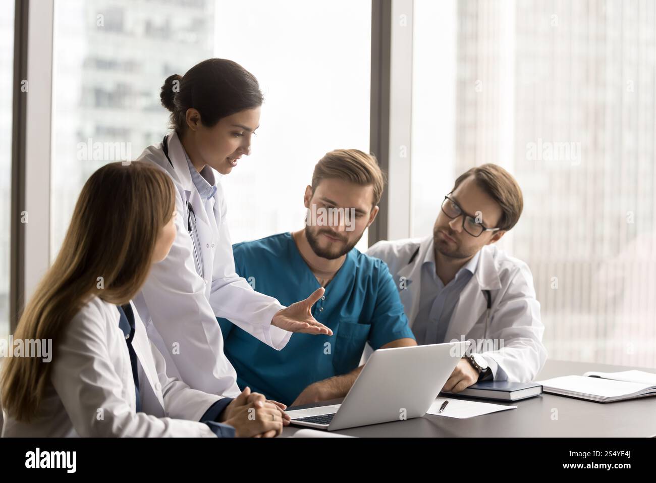 Group of multinational doctors gathers together to discuss patient case ...