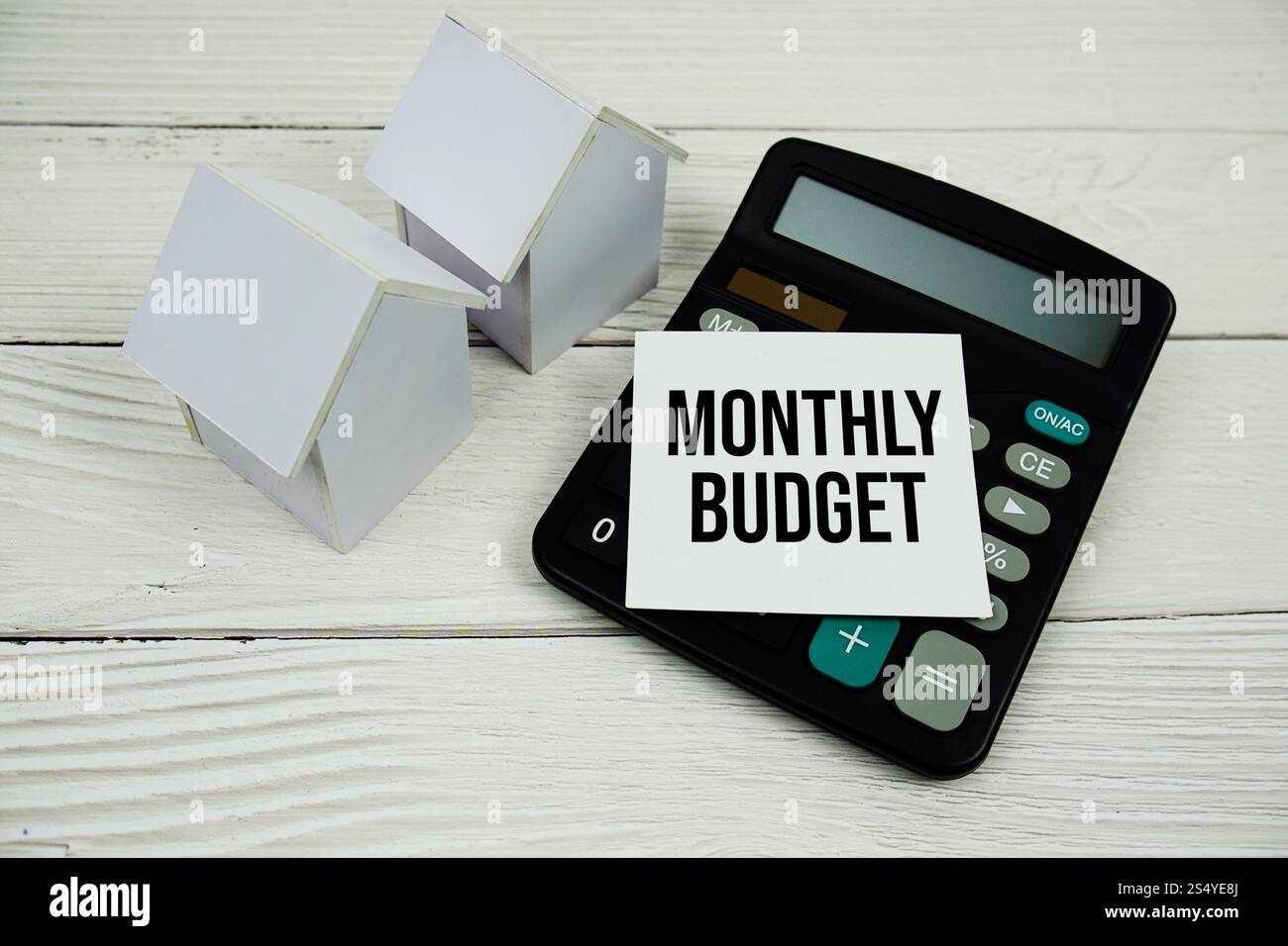 Monthly Budget text message on sticky note with home model and ...