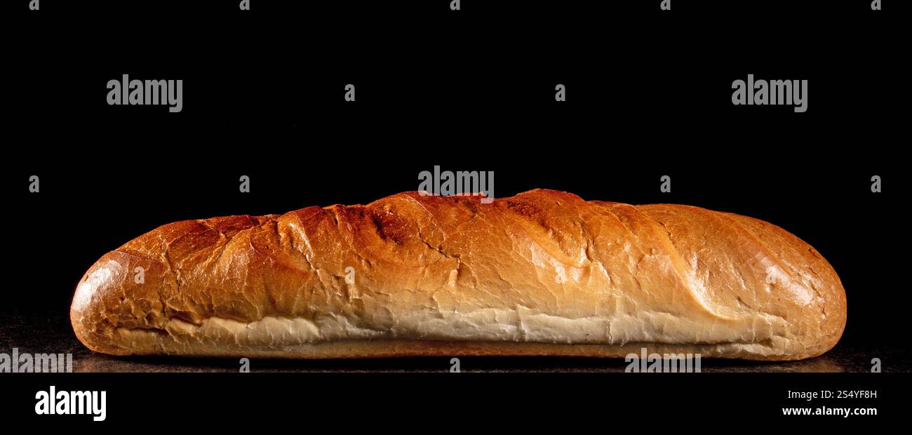 French loaf on black background, frontal view, low key photo Stock ...