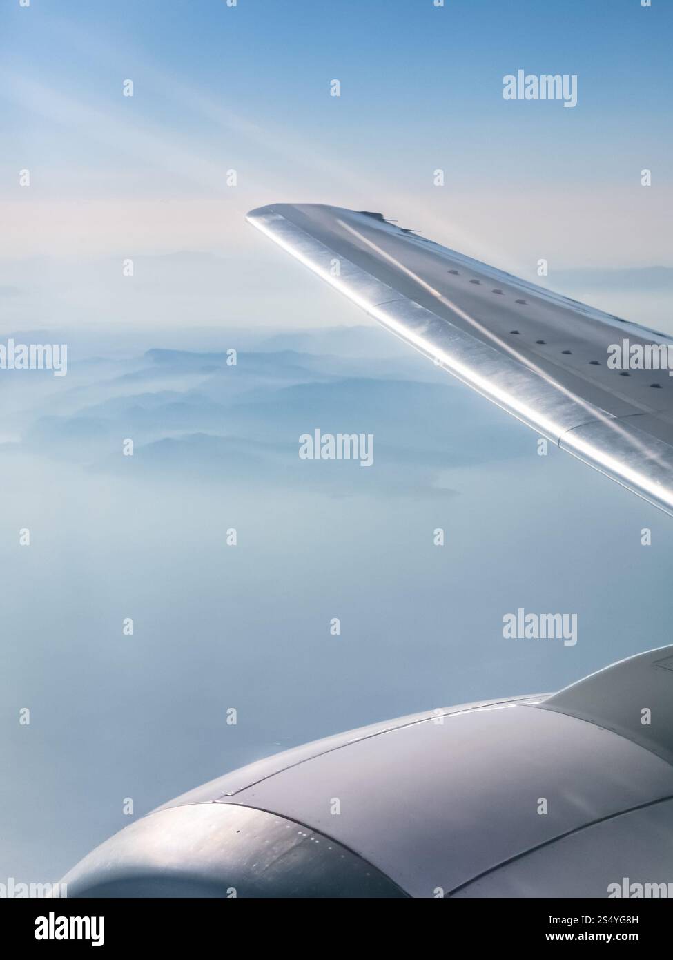 View from the airplane - wing of aircraft and view of mountains and ...