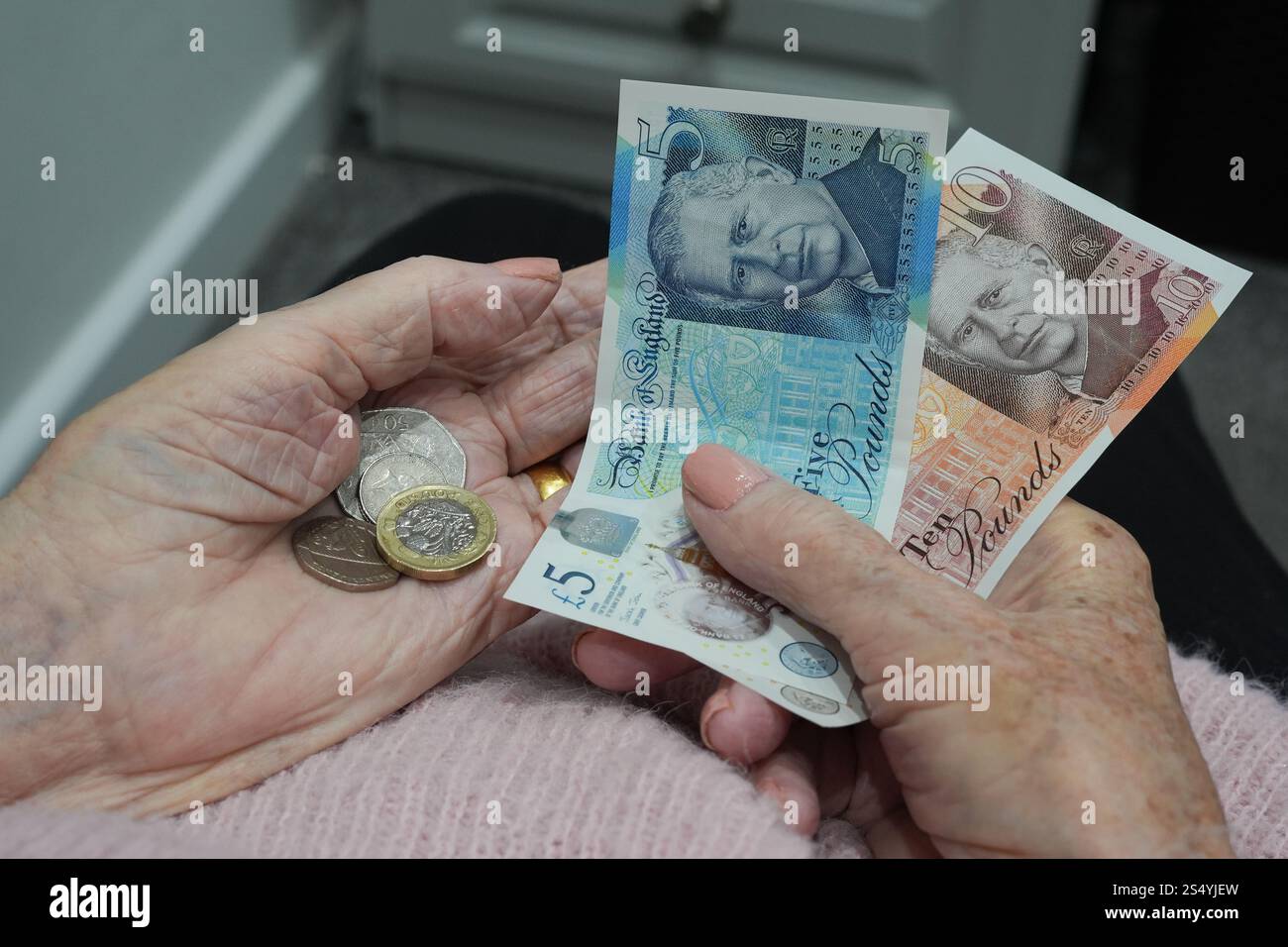 Picture posed by model An old age pensioner holding bank notes and ...