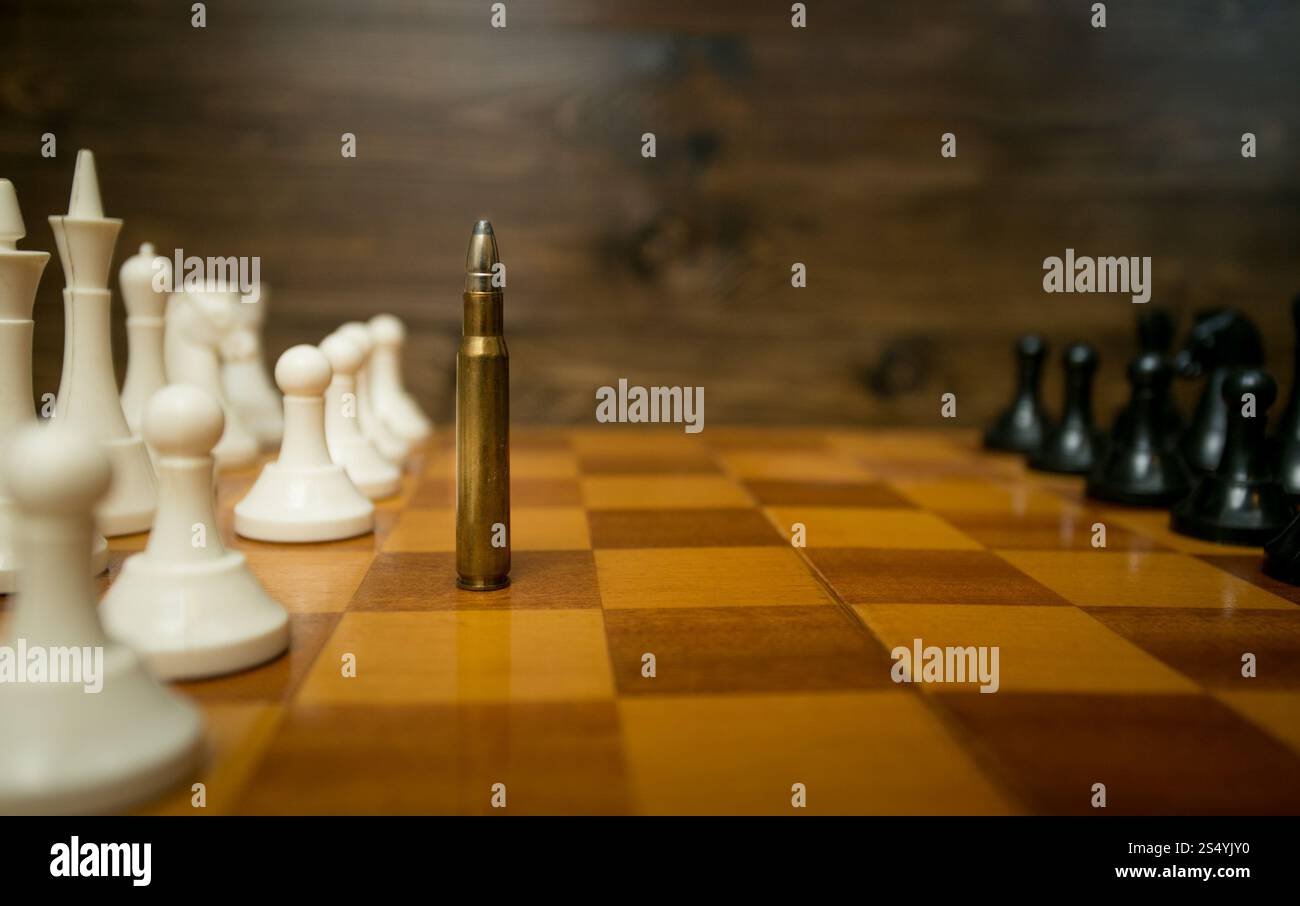 Conceptual photo of using bullet instead of chess piece Stock Photo - Alamy