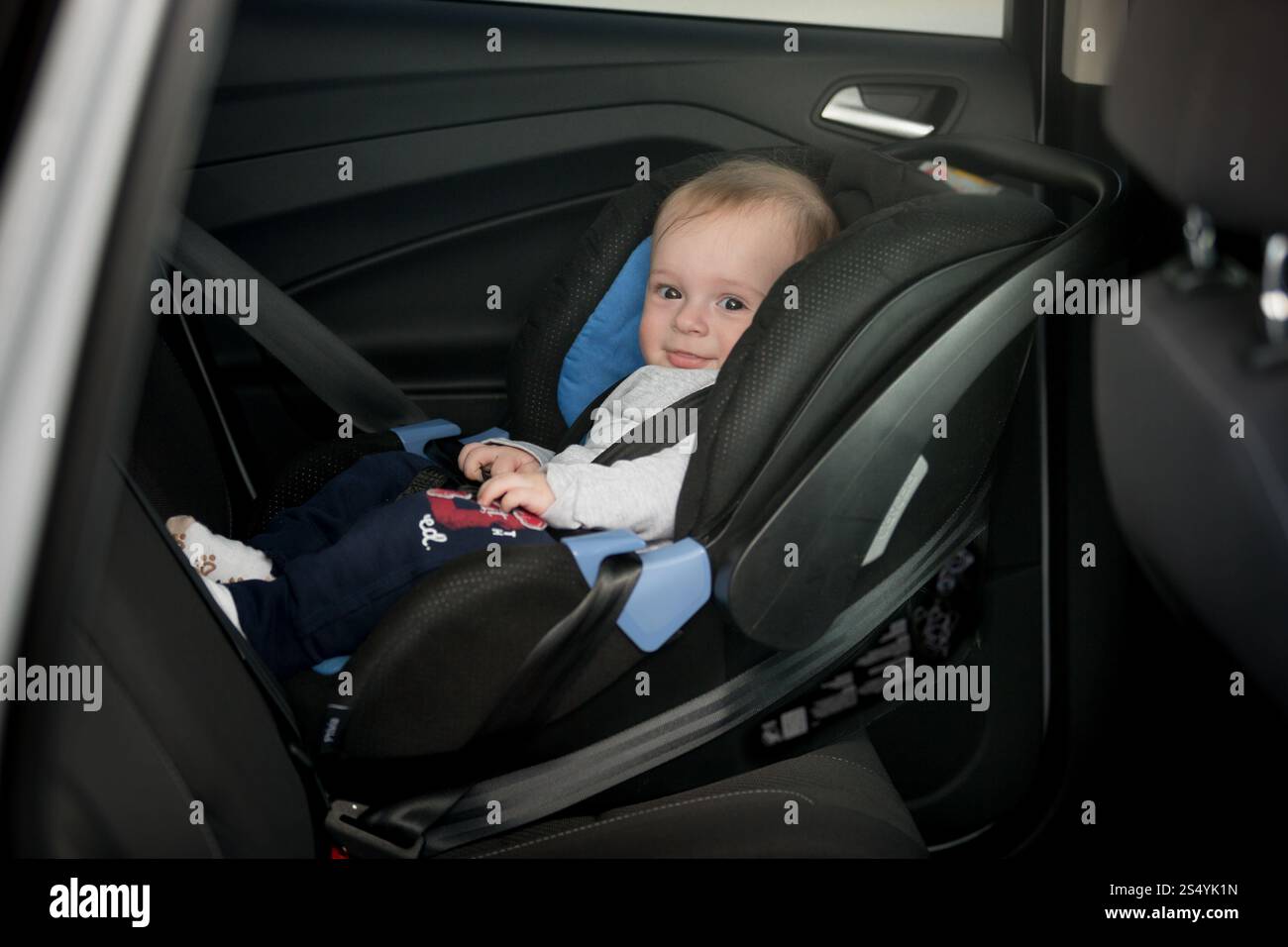 Little smiling baby on back seat Stock Photo - Alamy