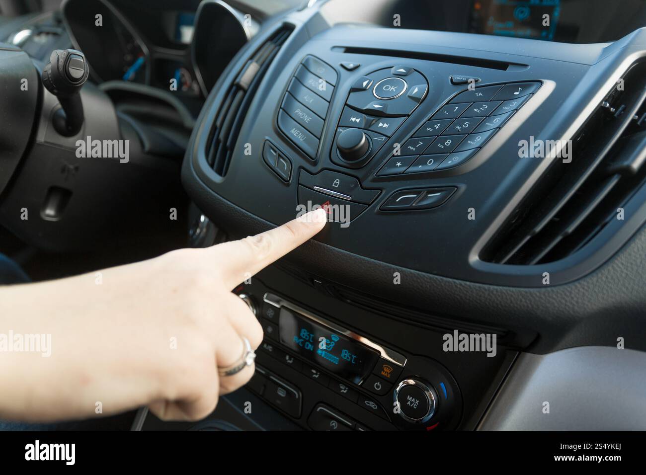 Closeup of woman pressing red car emergency button Stock Photo - Alamy