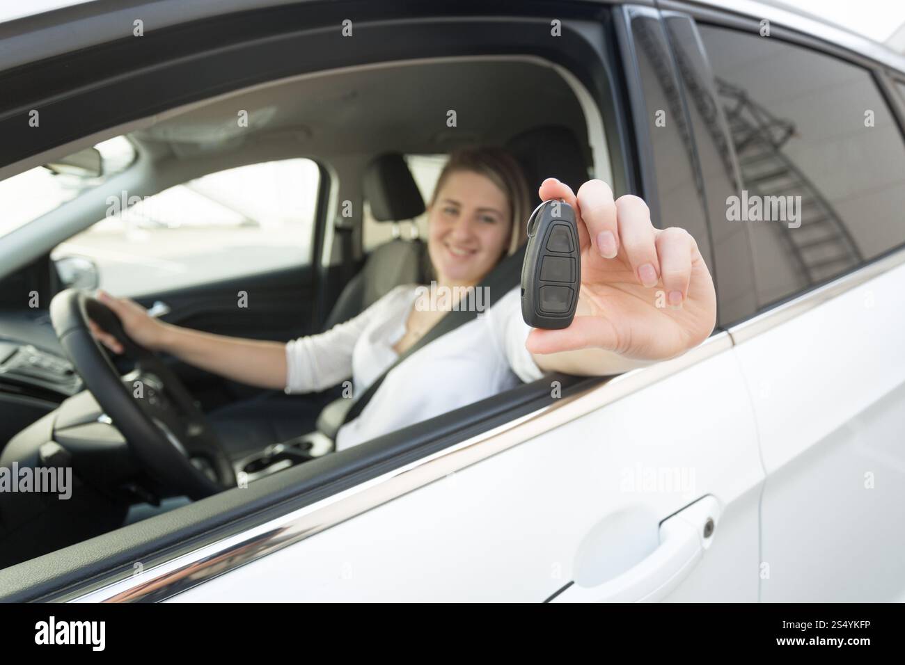 Closeup of female driver showing keys through open window of car Stock ...