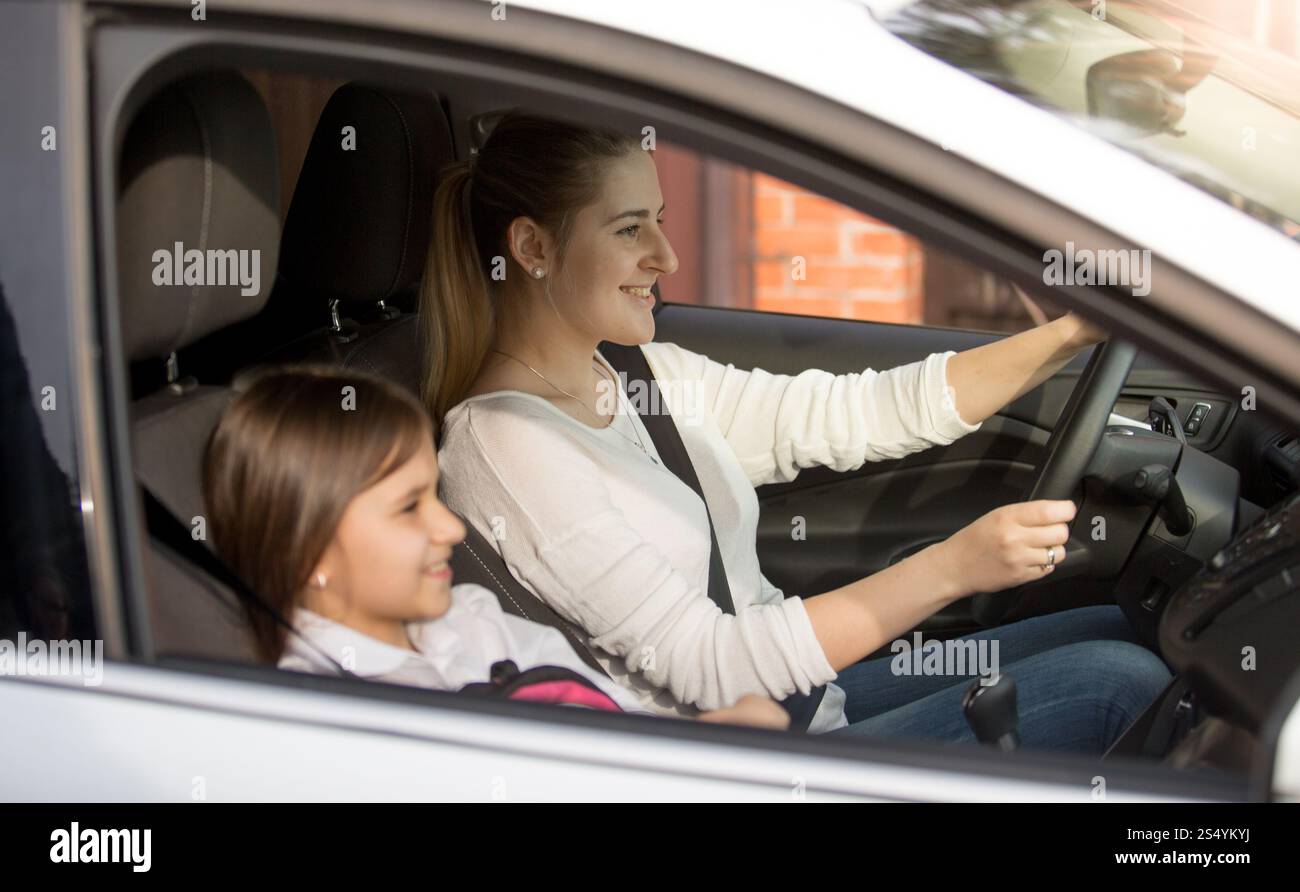 Young mother driving car to school with daughter Stock Photo - Alamy