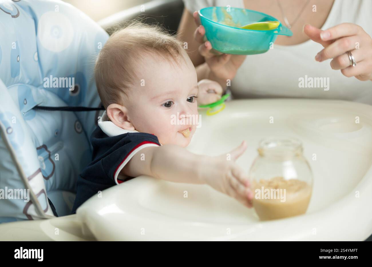 Mother feeding son porridge hi-res stock photography and images - Alamy