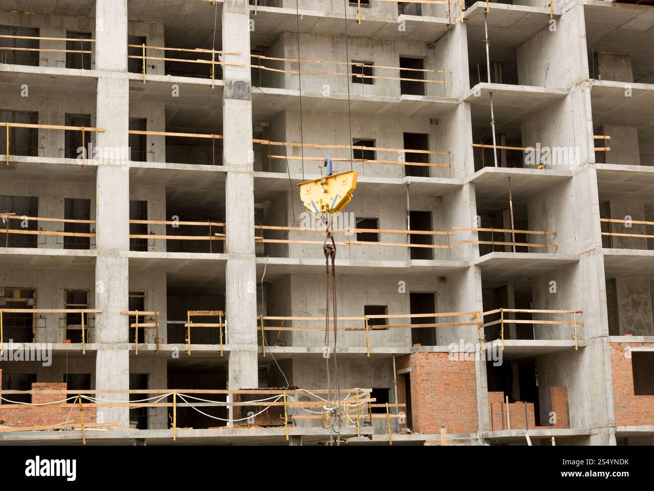 Building crane lifting blocks on construction site Stock Photo - Alamy
